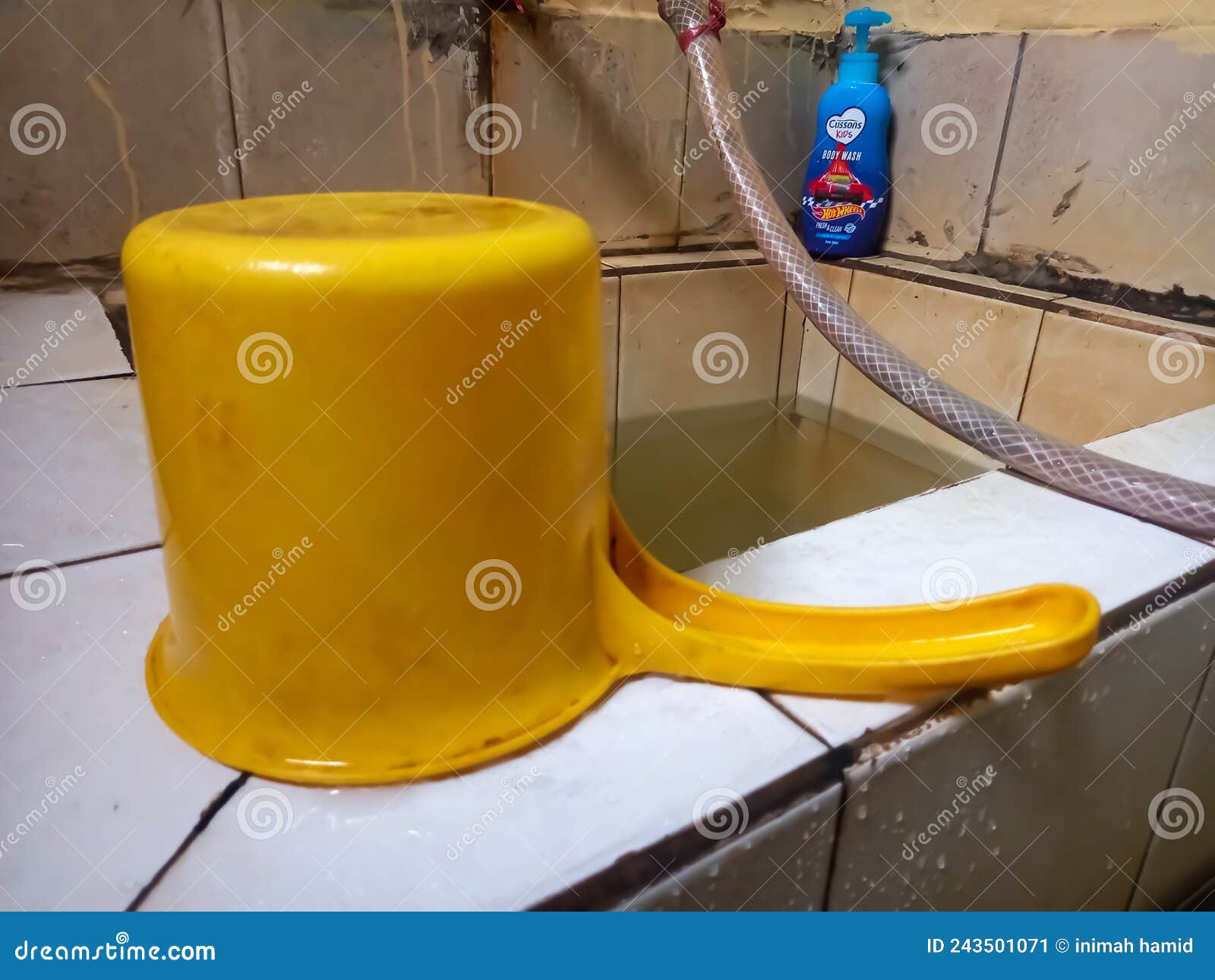 The Yellow Water Dipper is Above the Bathroom Tub Editorial Photo ...