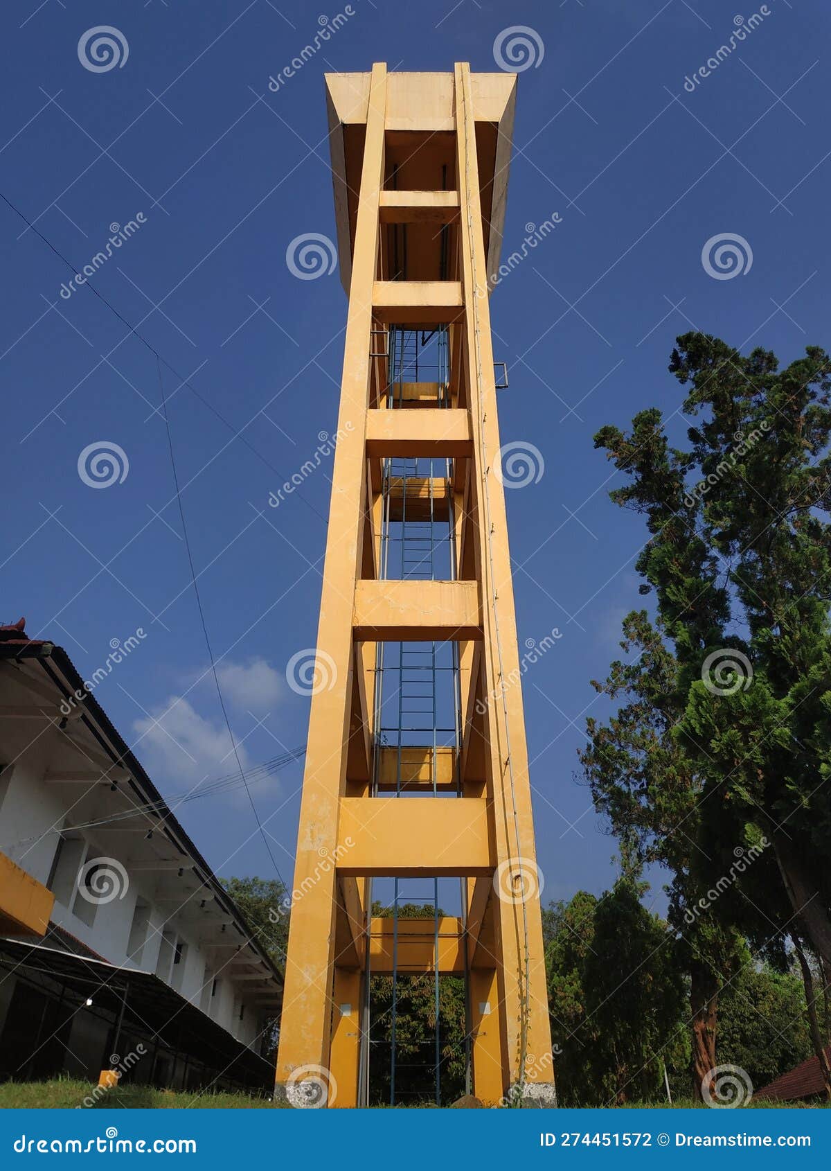Yellow Water Tower stock photo. Image of clouds, building - 274451572