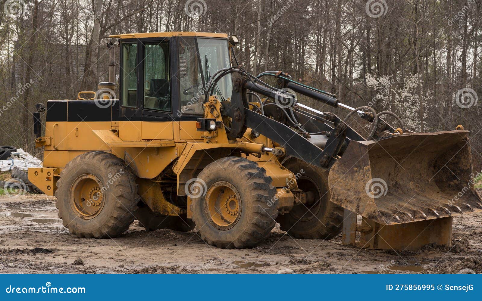 A Yellow Wheel Loader on a Muddy Construction Site . Stock Image ...
