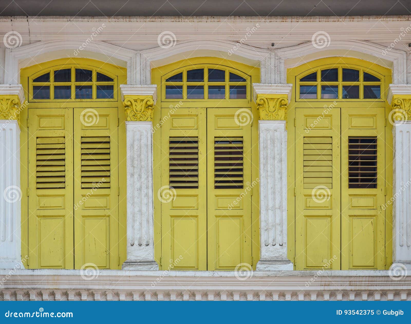 Yellow Windows with Shutters on White Wall Stock Image - Image of ...