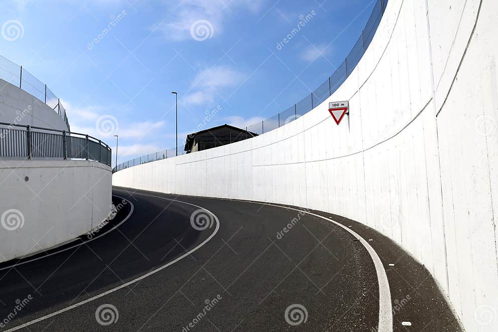 Yield Sign on White Concrete Wall in the Road Curve at the Exit of an ...