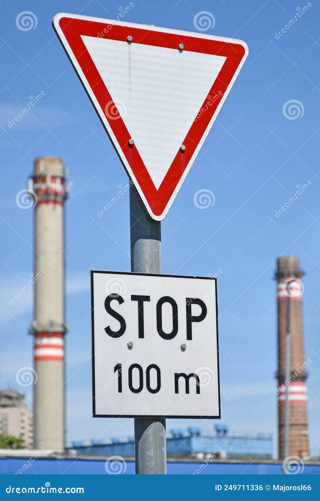 Yield Traffic Sign and Smoke Stacks Stock Photo - Image of people, road ...