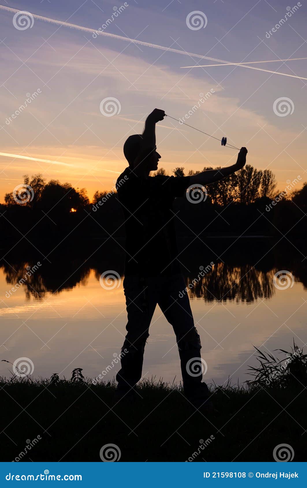Yo-Yo player by the lake stock photo. Image of human - 21598108