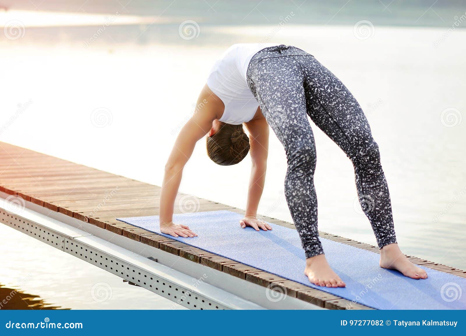 Yoga Girl Making Bridge Yoga Pose Facing the Sunrise at the Rive Stock ...