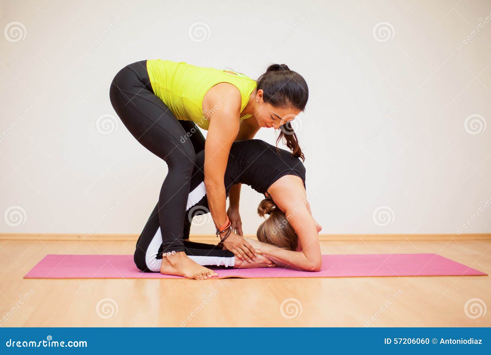 Yoga Instructor Assisting a Student Stock Photo - Image of exercise ...