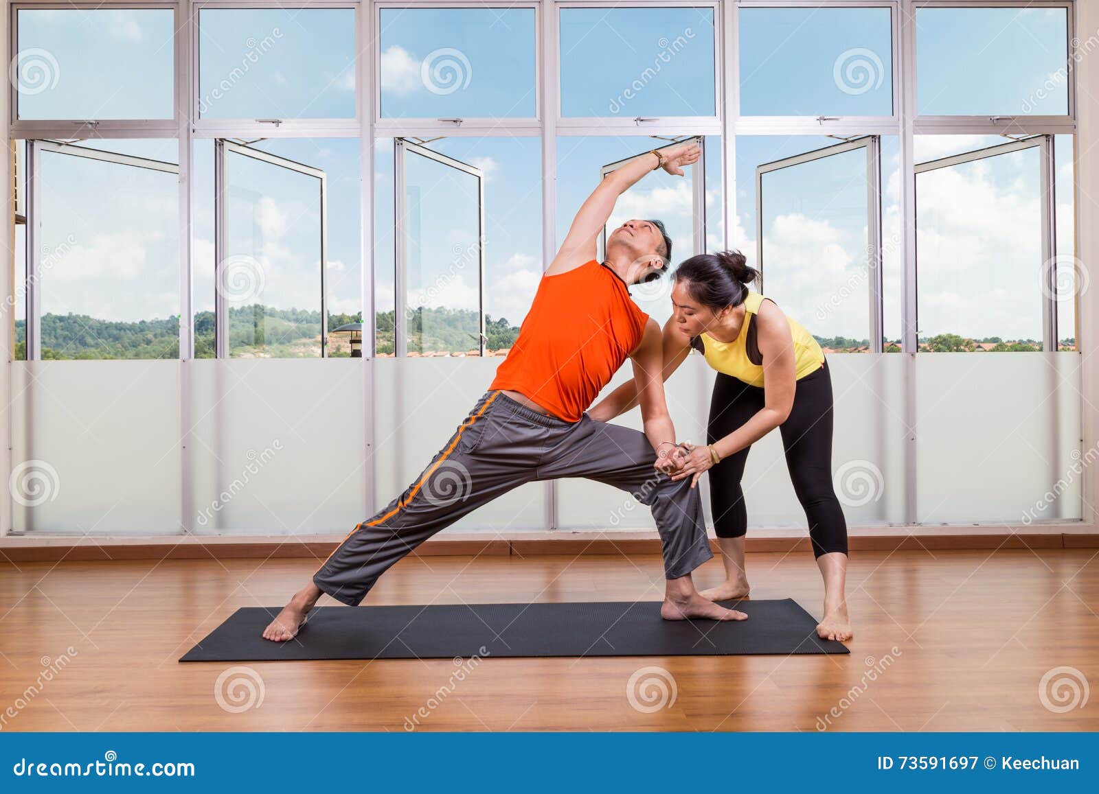 Yoga Instructor Guiding Student Perform Extended Side Angle Pose Stock ...