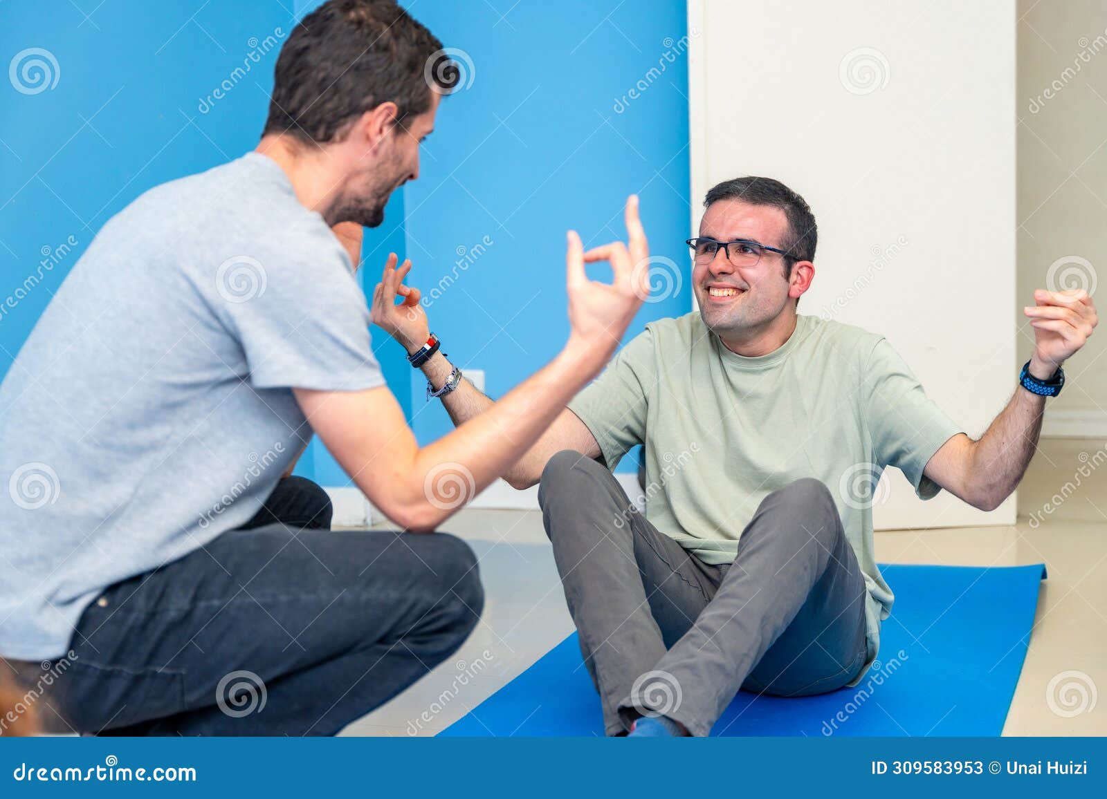 Yoga Instructor Helping a Disabled Man during a Yoga Pose Stock Image ...