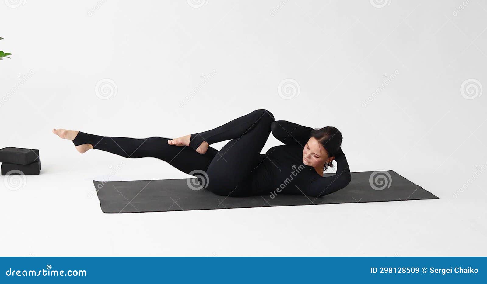 A Yoga Instructor Performs an Exercise Asymmetrical Navasana in ...