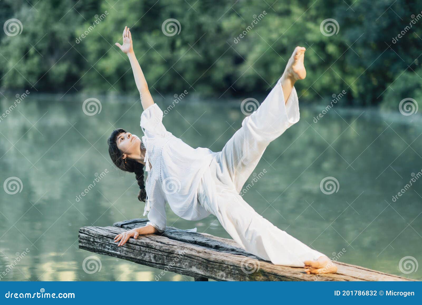 Yoga by the Lake â€“ Young Woman Doing Yoga Exercise Plank Star Pose ...