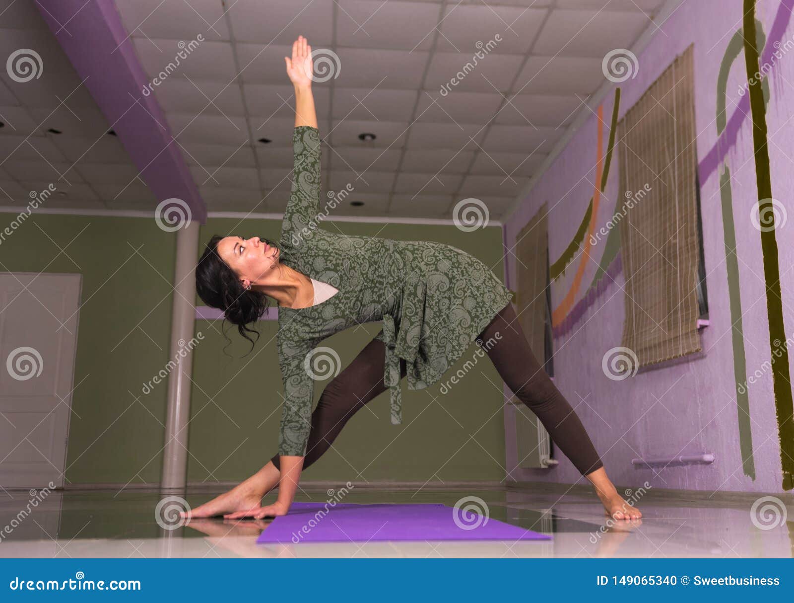 Yoga Instructor Doing Yoga Stretches in a Studio Stock Photo - Image of ...