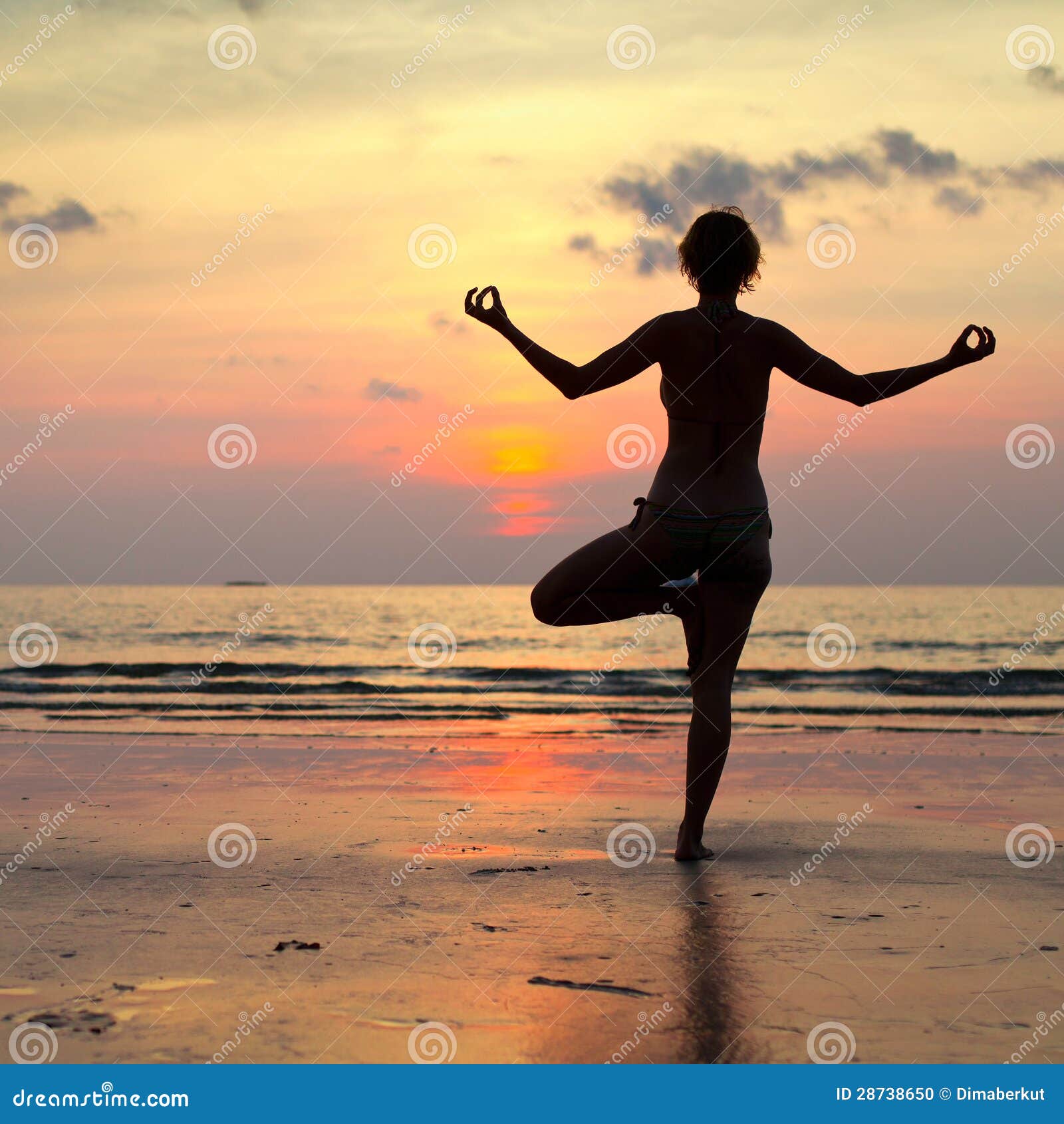Yoga Woman Performs an Exercise on the Beach during Sunset Stock Photo ...
