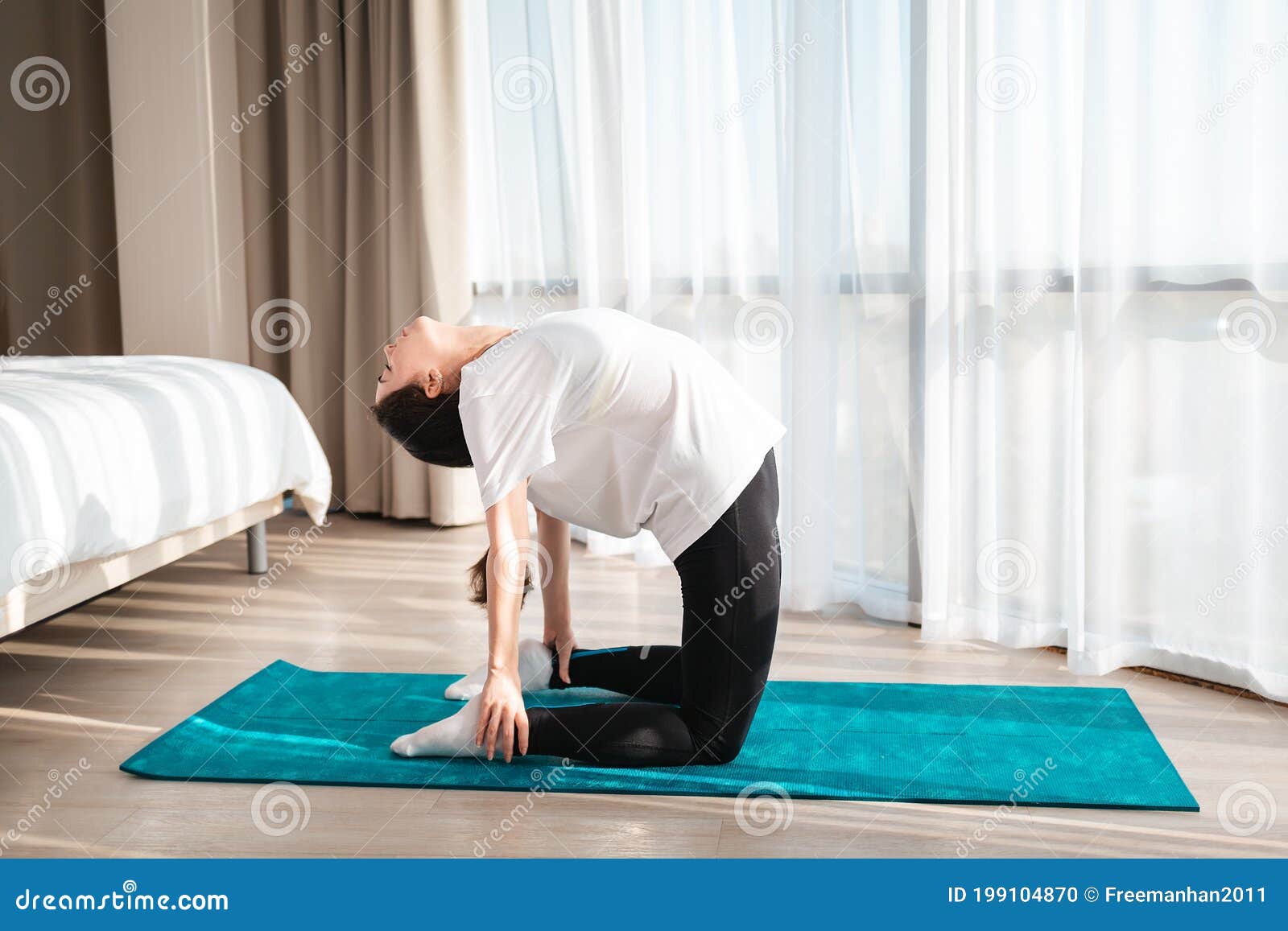 Yoga. a Young Woman Does a Back Stretching Exercise. Side View. Copy ...