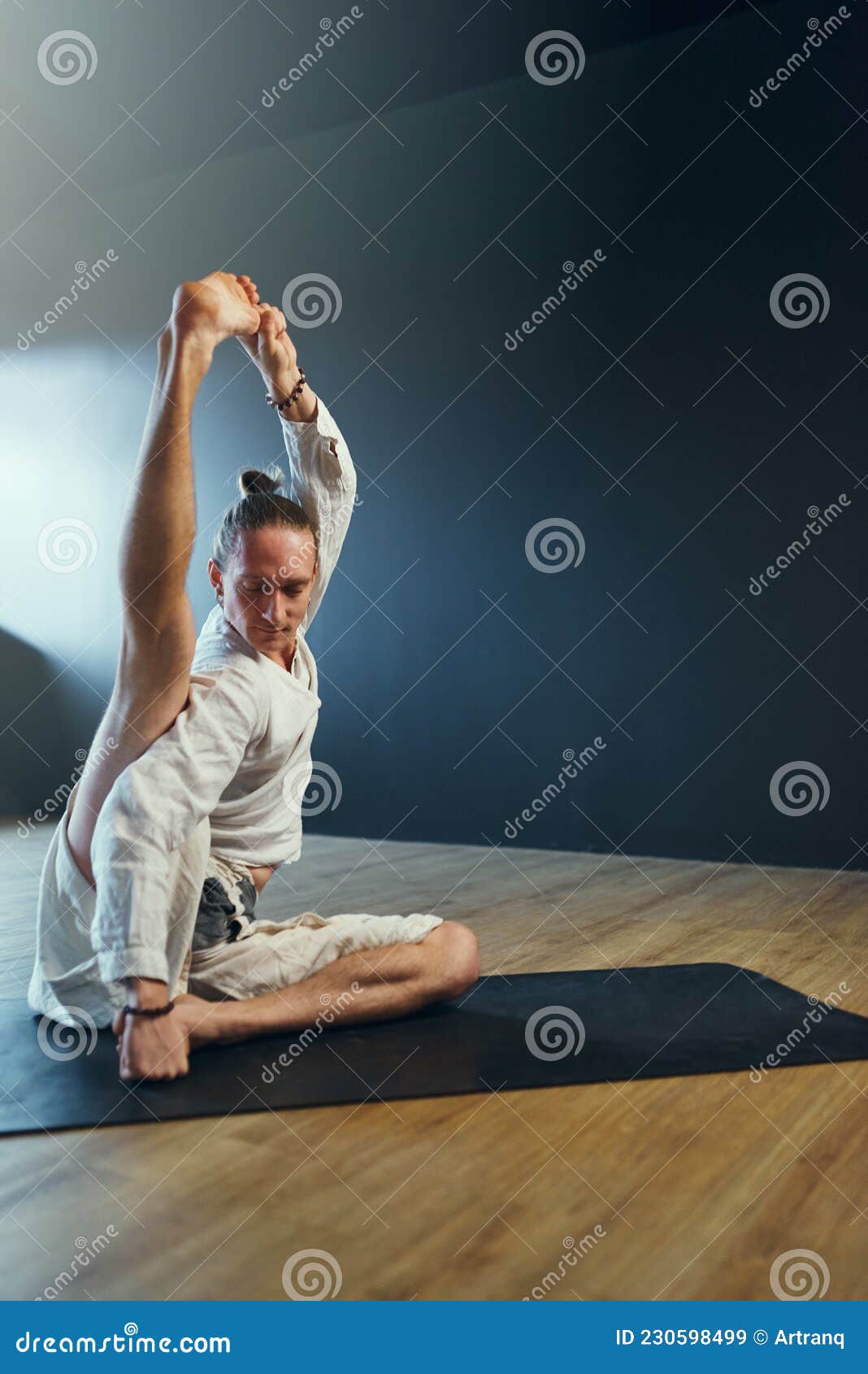 Yogi Man Doing Eka Pada Sirsasana. Yoga Practice in the Studio. Stock ...
