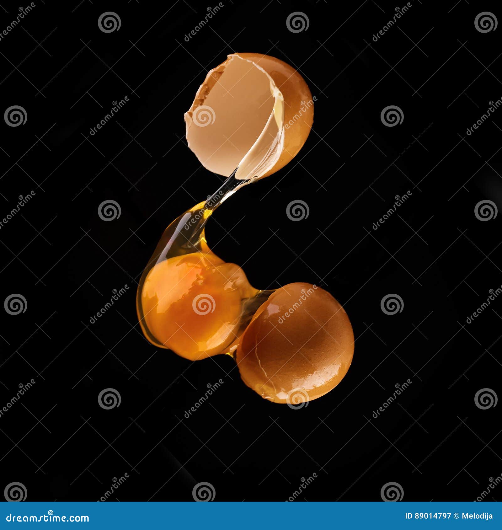 Yolk Dropping from Cracked Raw Egg Divided Stock Image - Image of ...