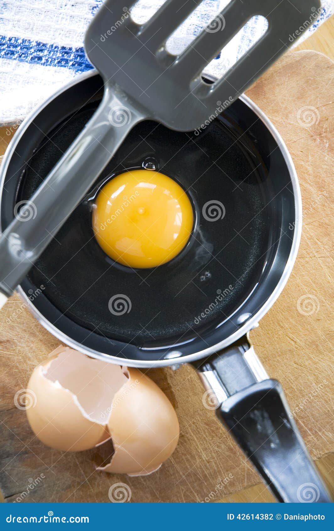 Yolk in pan with eggshell stock photo. Image of board - 42614382