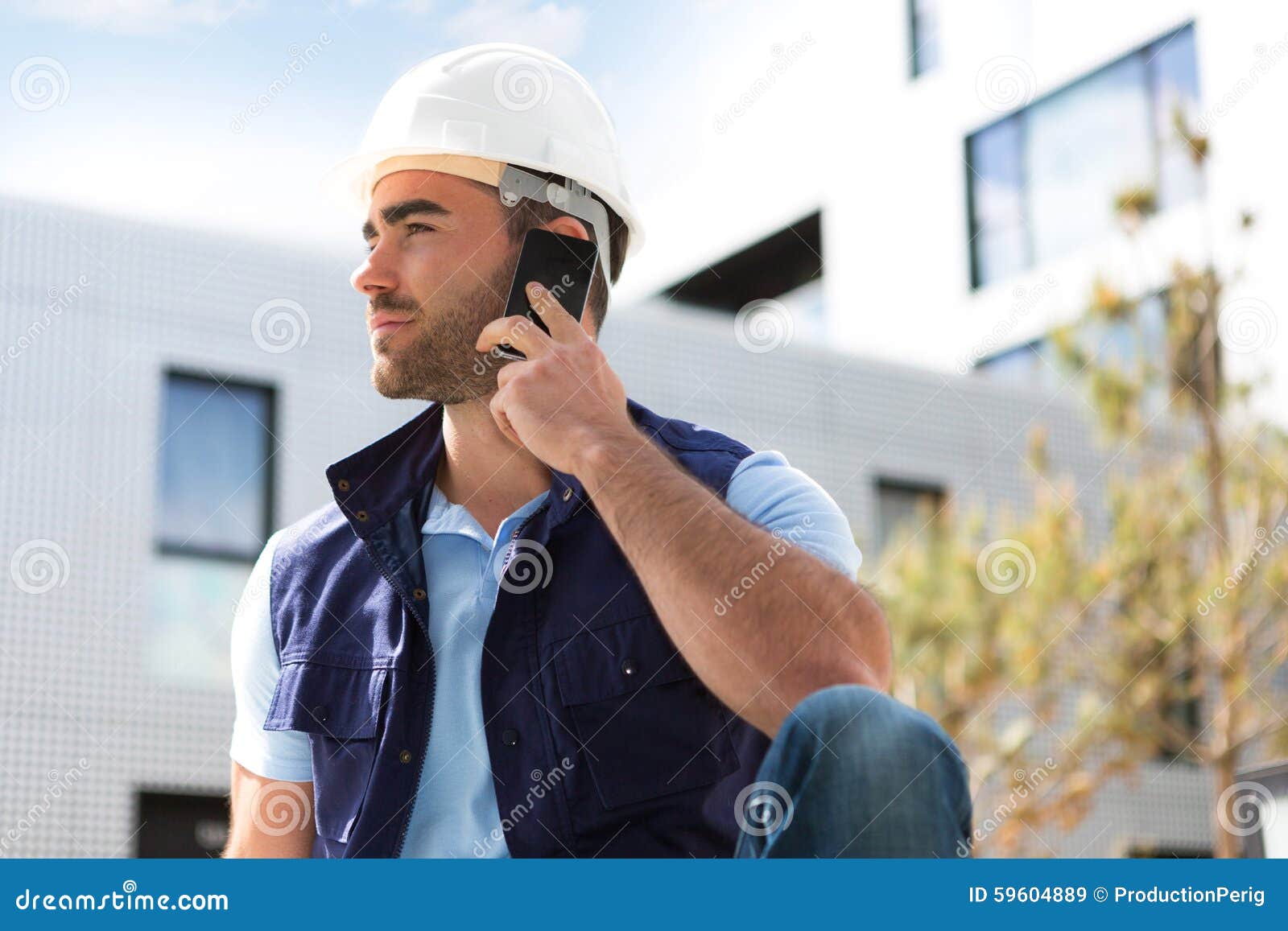 Yong Attractive Worker Using Mobile Phone on a Construction Sit Stock ...