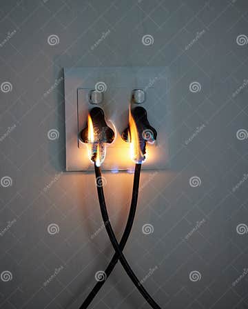 Are You Covered. Two Plugs in a Wall Socket Catching Fire. Stock Image ...