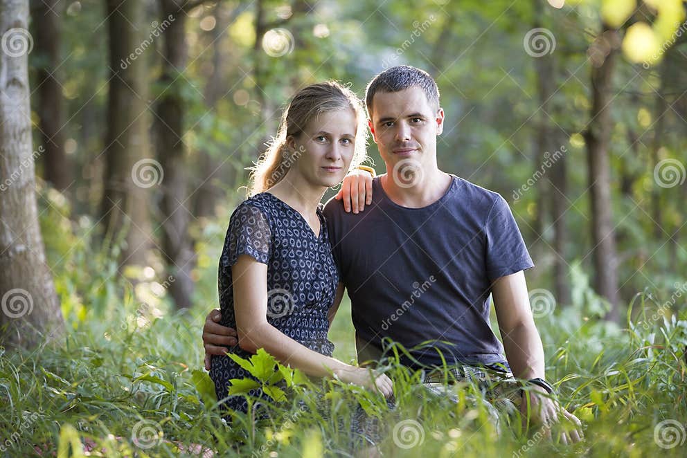 Youg Couple Man And A Woman Sitting Together Outdoors Enjoying Nature