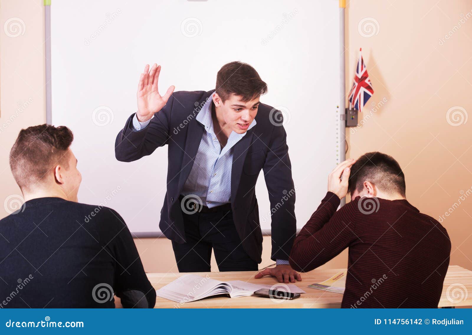 Youn Teacher Threatens the Distracted Student during the Lesson. Stock ...