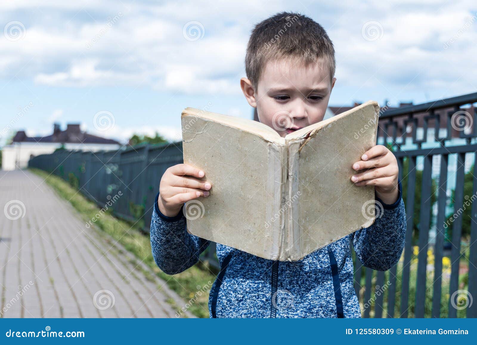 Yound Kid Reading Interesting Book at Walk. Concept of Reading an ...