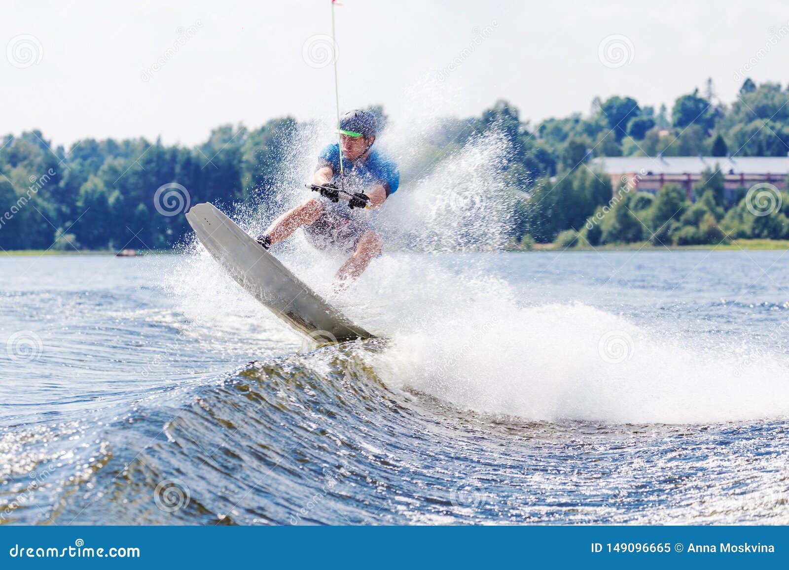 Young Active Man Riding Wakeboard on a Wave from a Motorboat on Summer ...