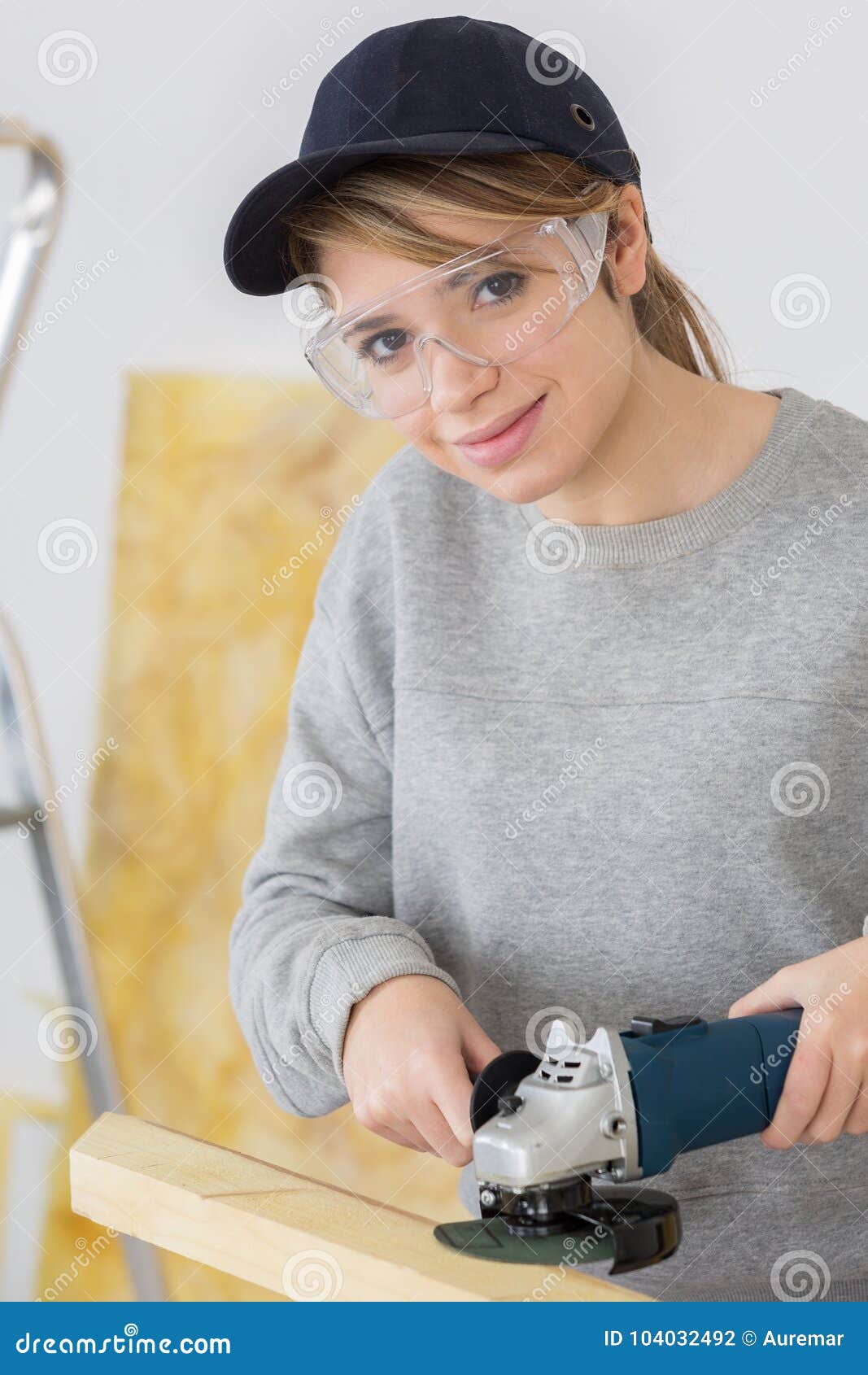 Young Adult Female Woodworker Using Grinder Stock Photo - Image of ...