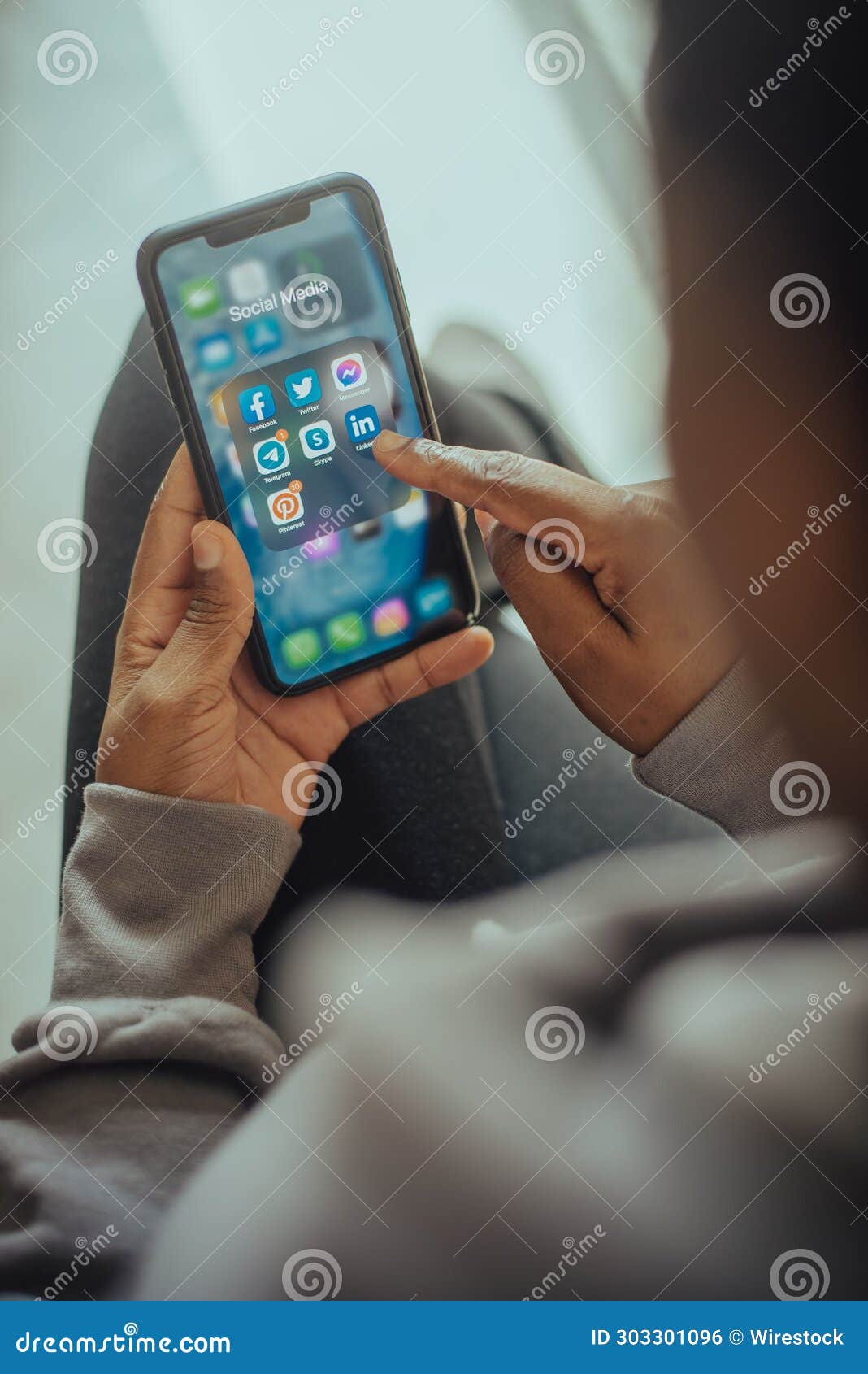 Young Adult Holding an IPhone in Their Hands, Likely Using a Social ...