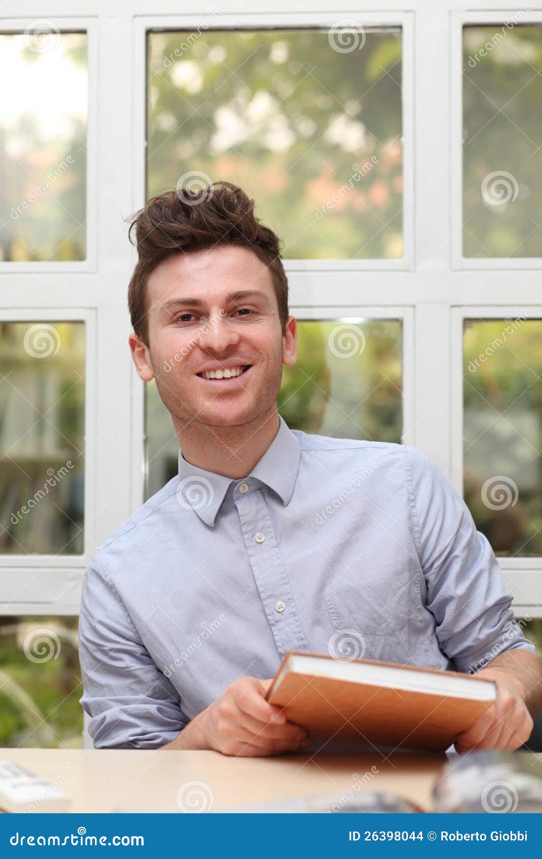 Young Adult Man with Note Book Stock Photo - Image of desk, room: 26398044