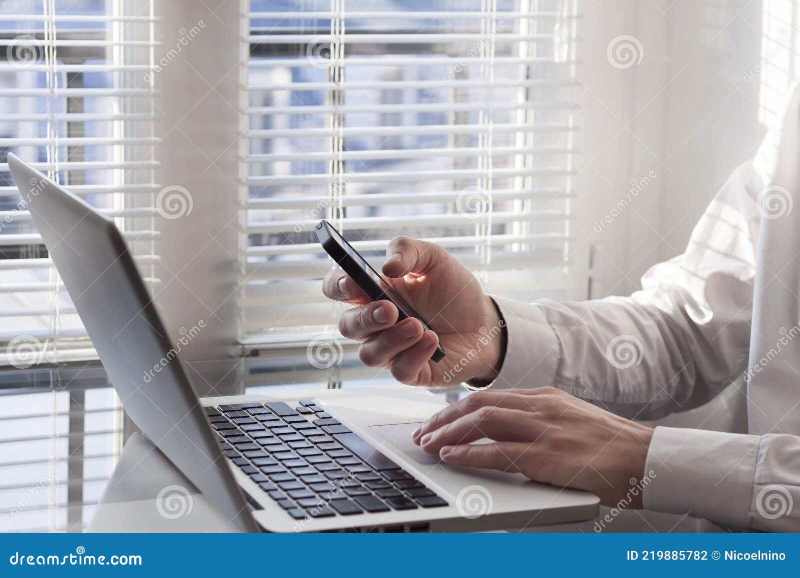 Young Adult Using Mobile Phone and Laptop at Home Stock Photo - Image ...