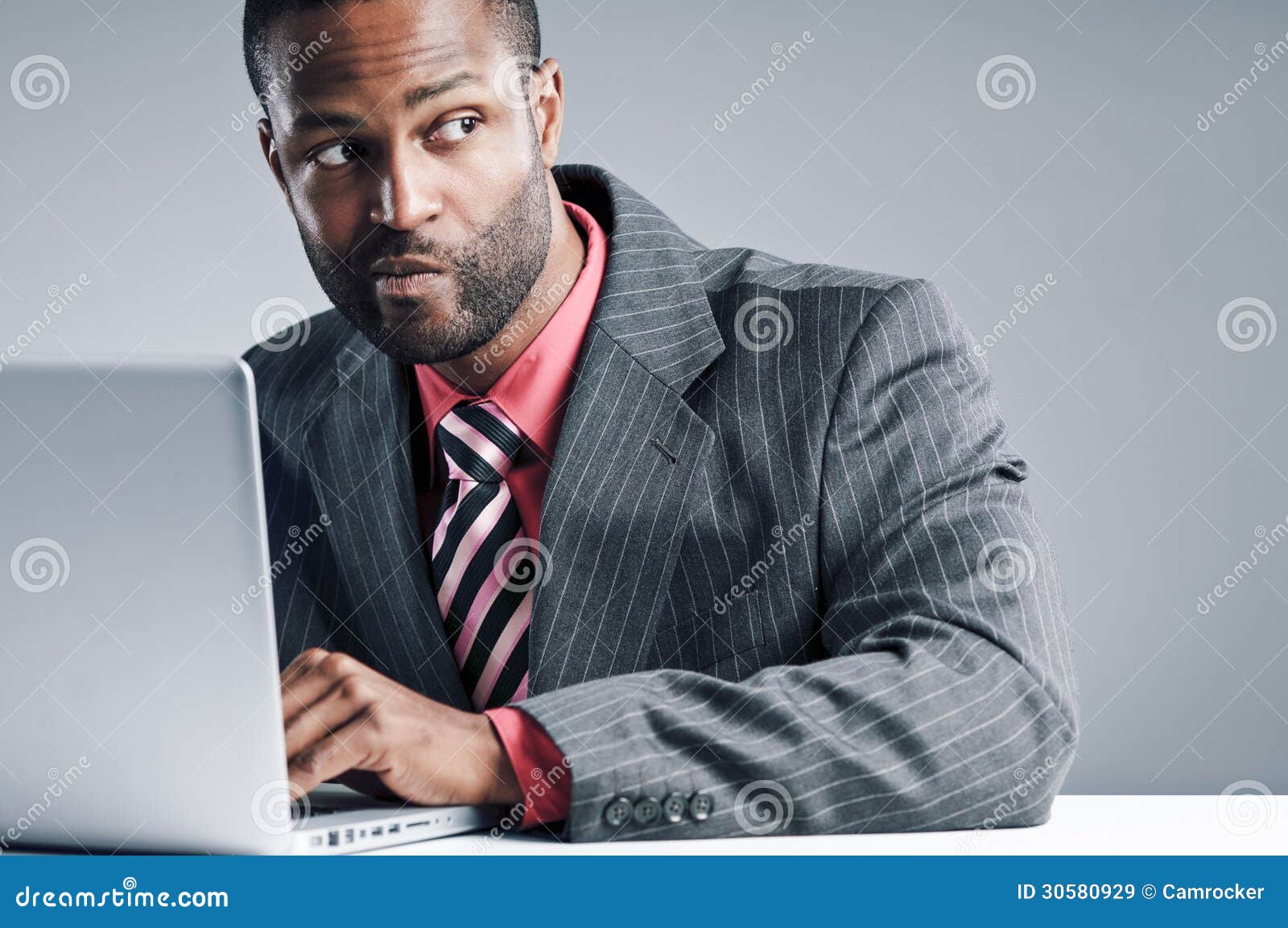 Young African American Businessman Being Sneaky on Laptop Stock Image ...