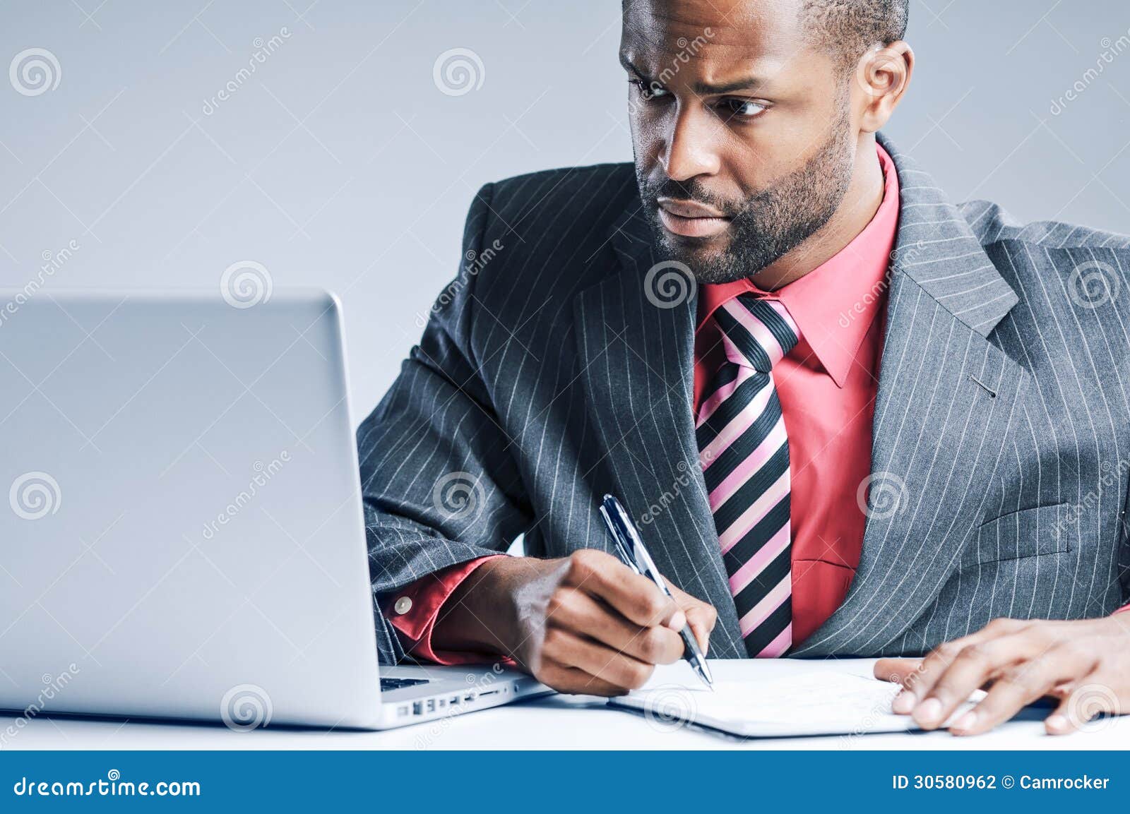 Young African American Businessman Being Sneaky on Laptop Stock Photo ...