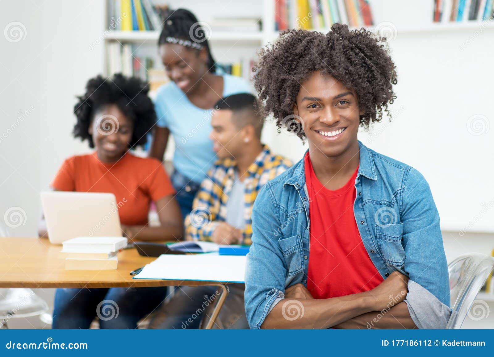 Young African American Computer Science Student with Group of Students ...