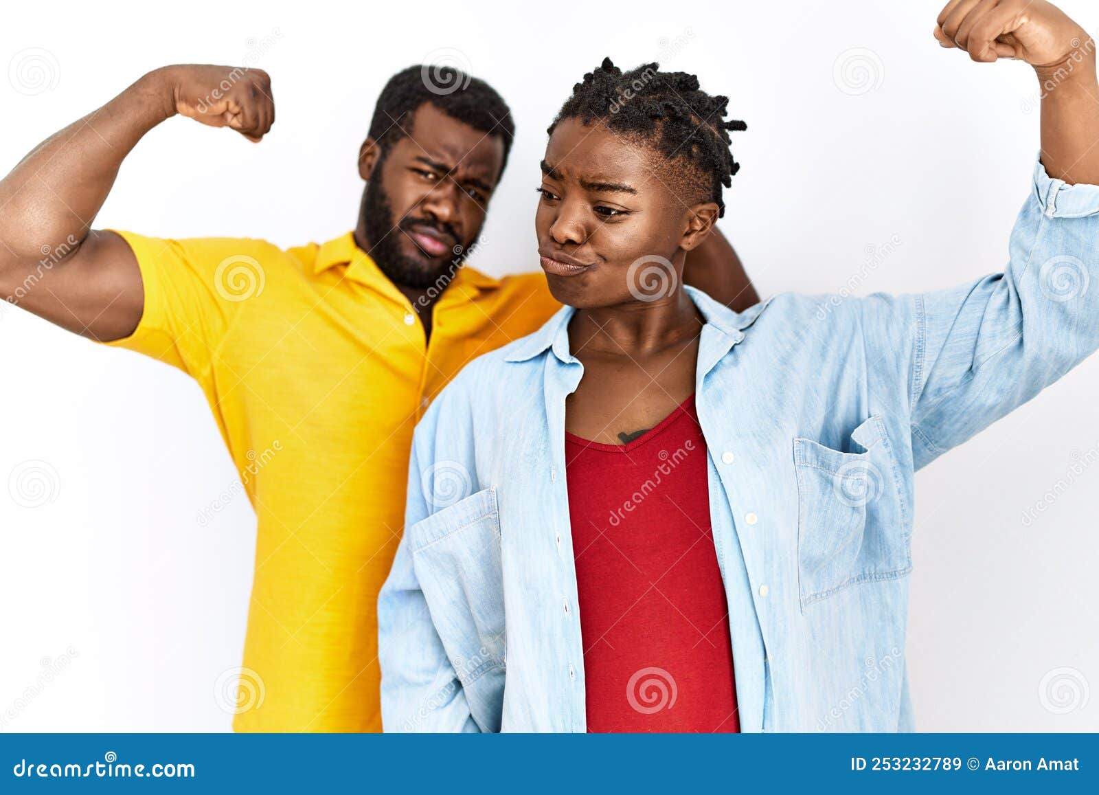 Young African American Couple Wearing Casual Clothes Showing Arms