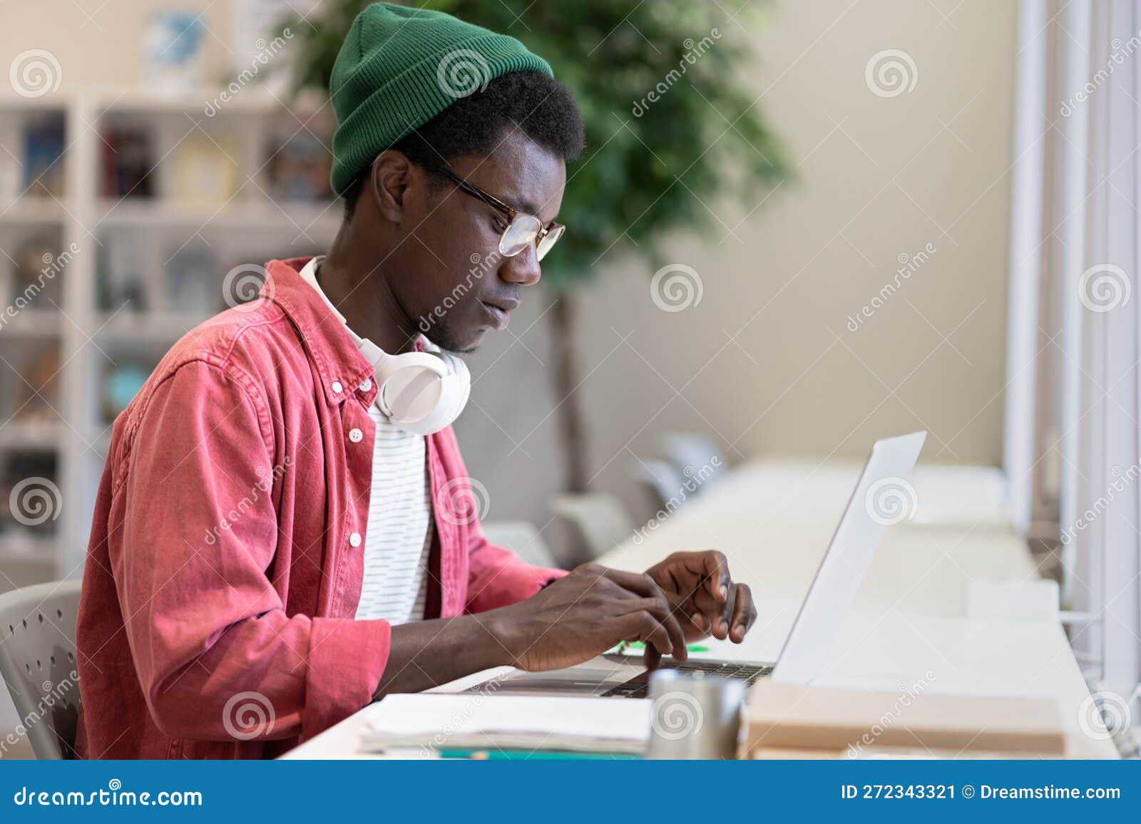 Young African American Man Freelancer Working on Laptop Using Public ...