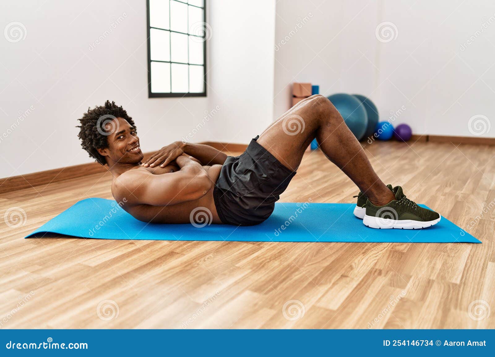 Young African American Man Training Abs Exercise at Gym Stock Photo ...