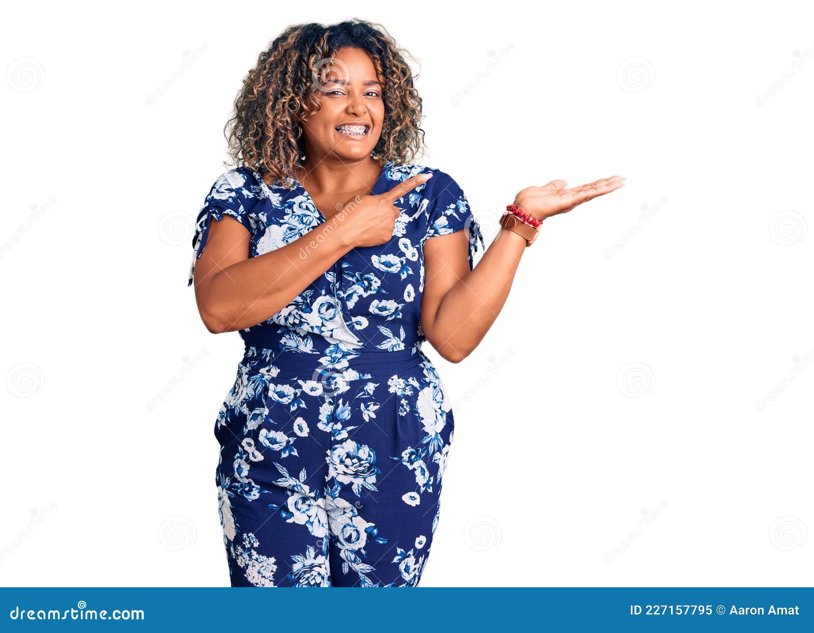Young African American Plus Size Woman Wearing Casual Clothes Amazed