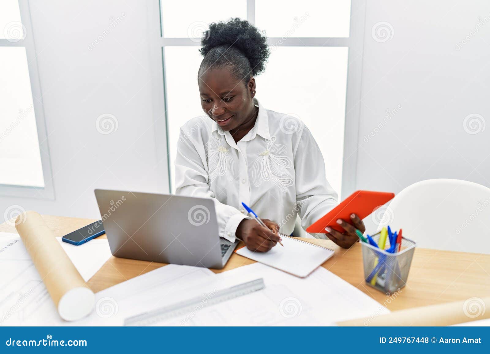 Young African American Woman Architect Using Touchpad Writing on ...