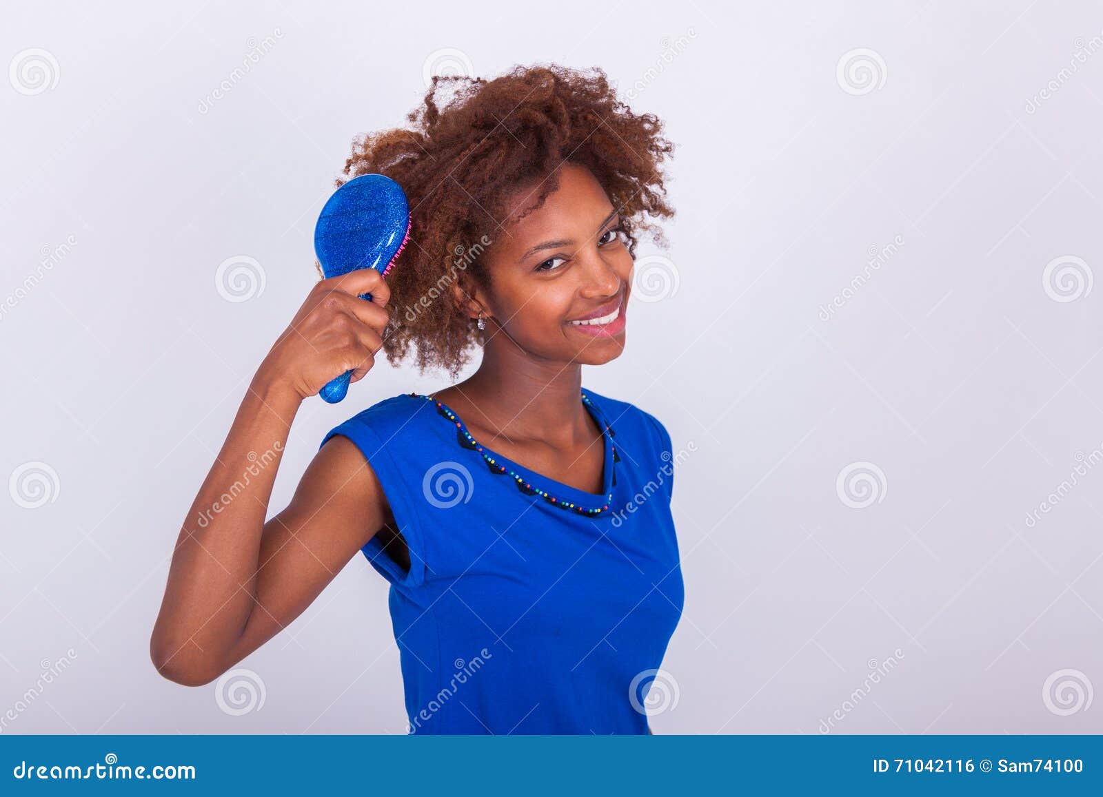 Young African American Woman Combing Her Frizzy Afro Hair - Black ... Young African American Woman Combing Her Frizzy Afro Hair - Black ...