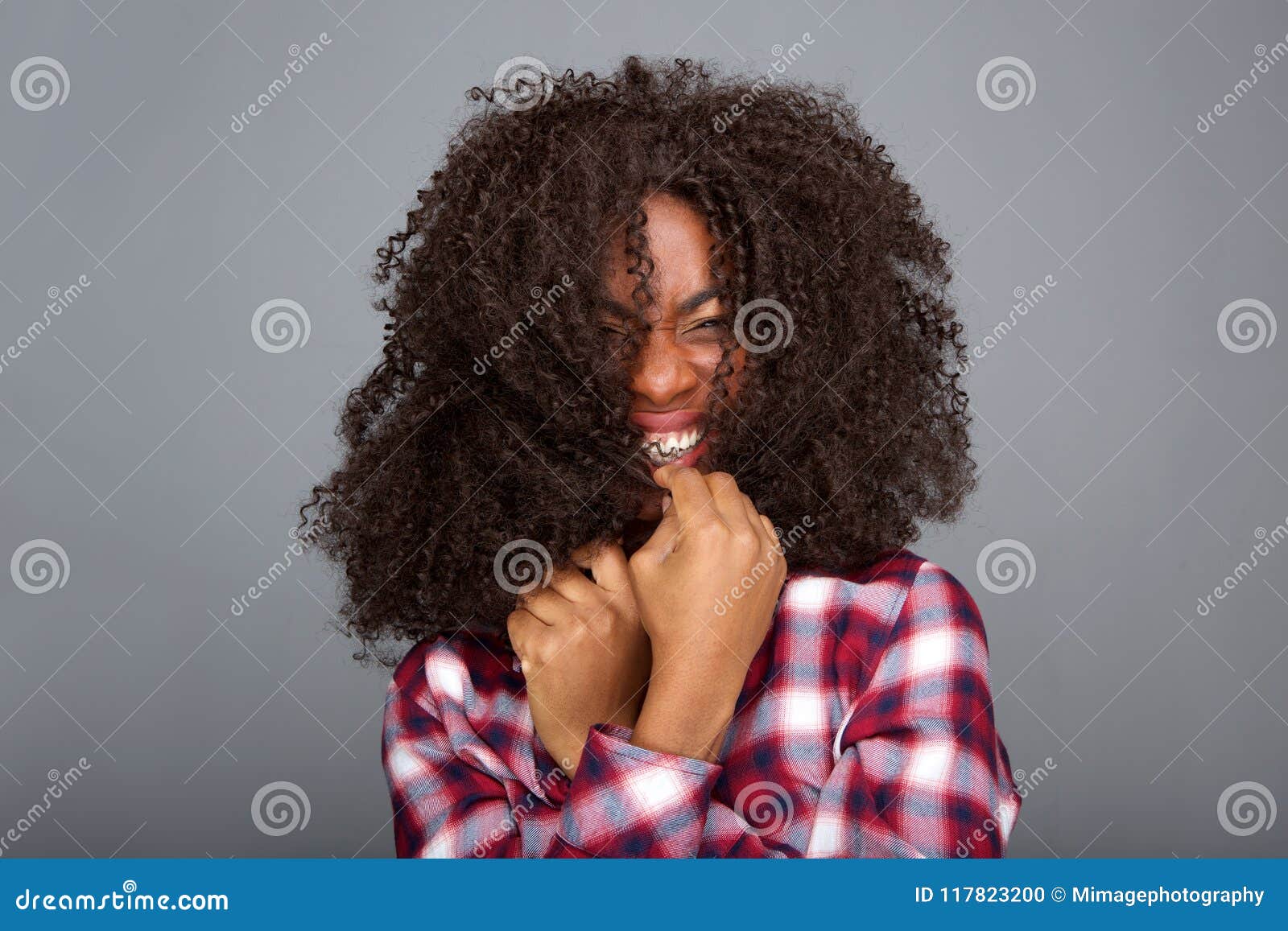 Young African American Woman Laughing With Hair Covering Her Face Stock