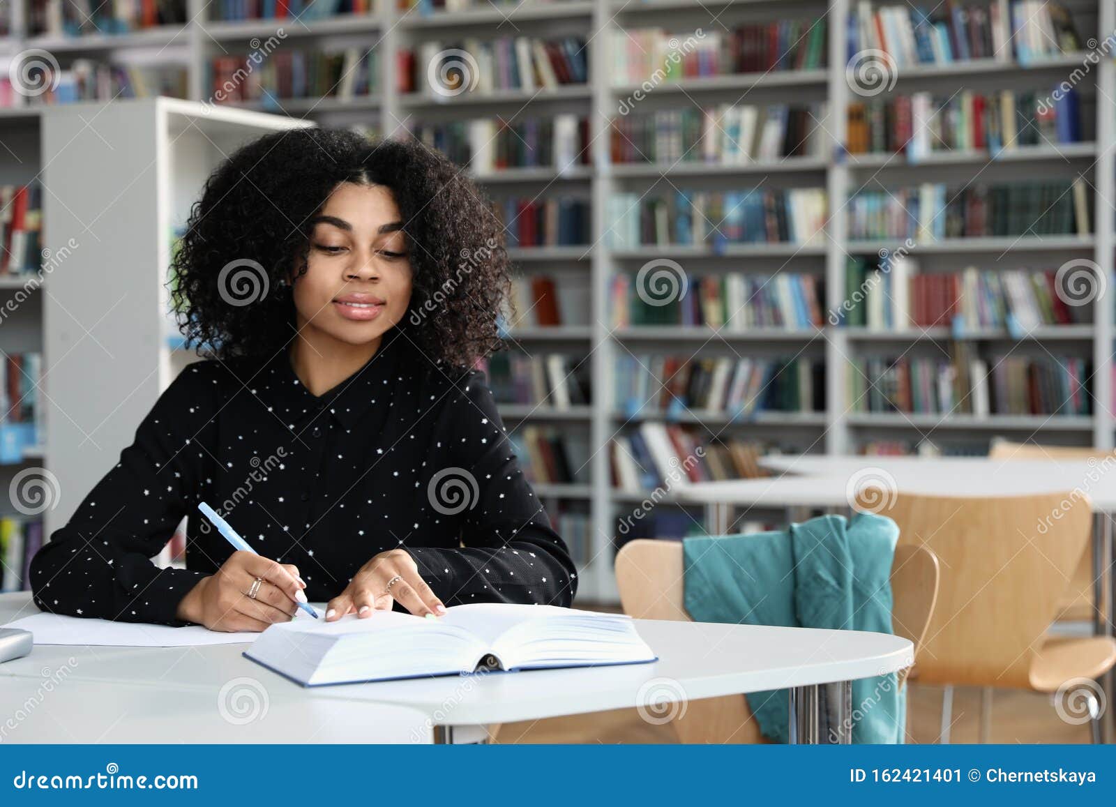 Young African-American Woman Studying at Table Stock Image - Image of ...
