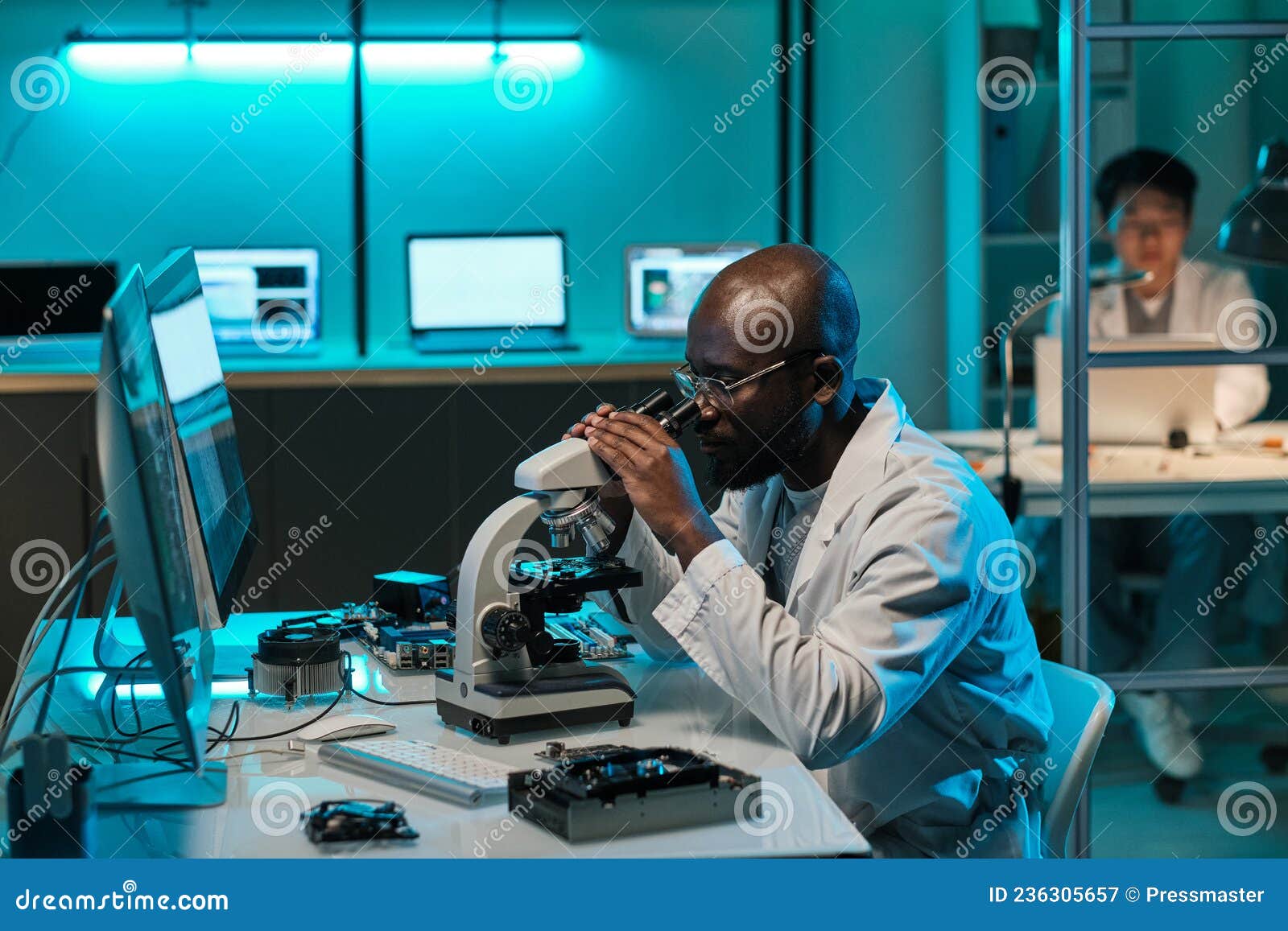 Young African Laboratory Worker Looking in Microscope Stock Image ...