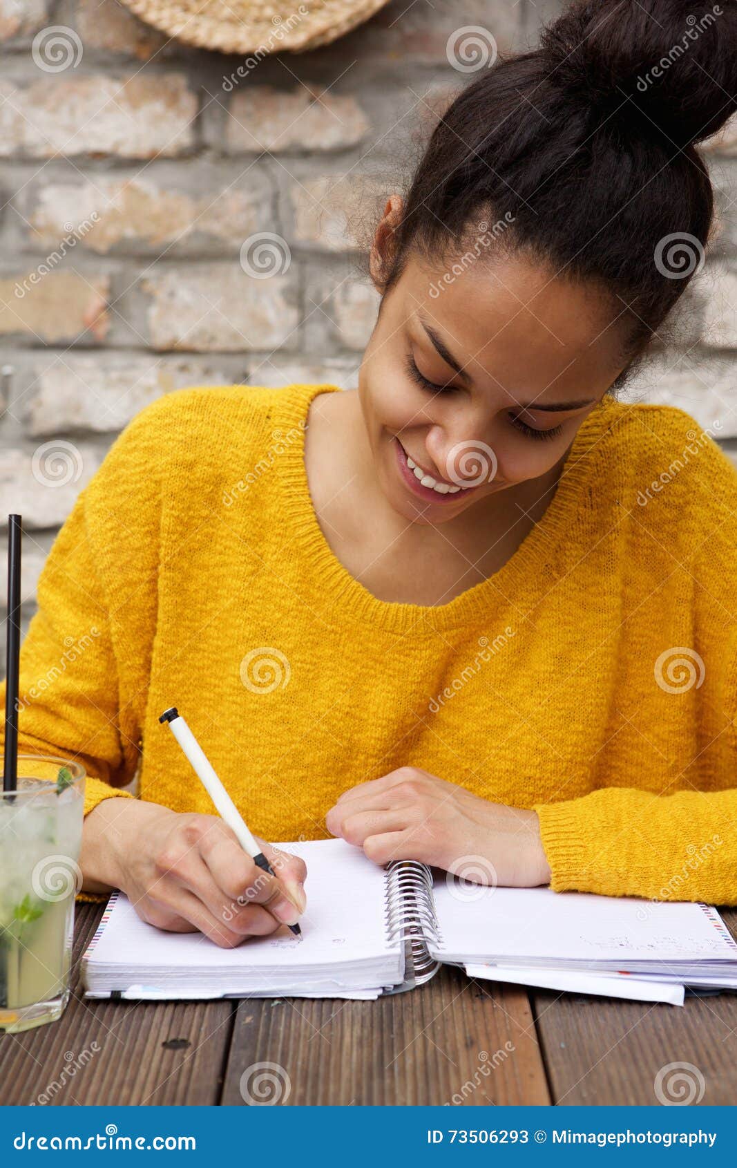 Young African Lady Sitting at Cafe Table and Writing Notes Stock Image ...
