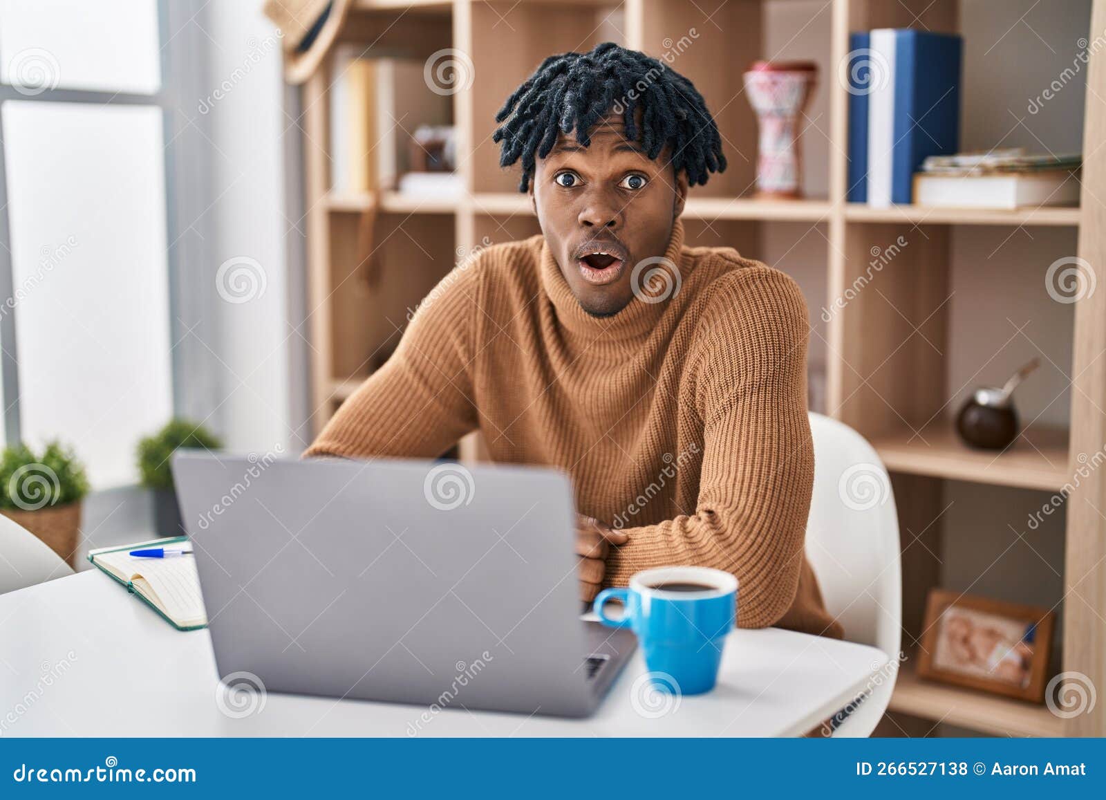 Young African Man with Dreadlocks Working Using Computer Laptop Afraid ...