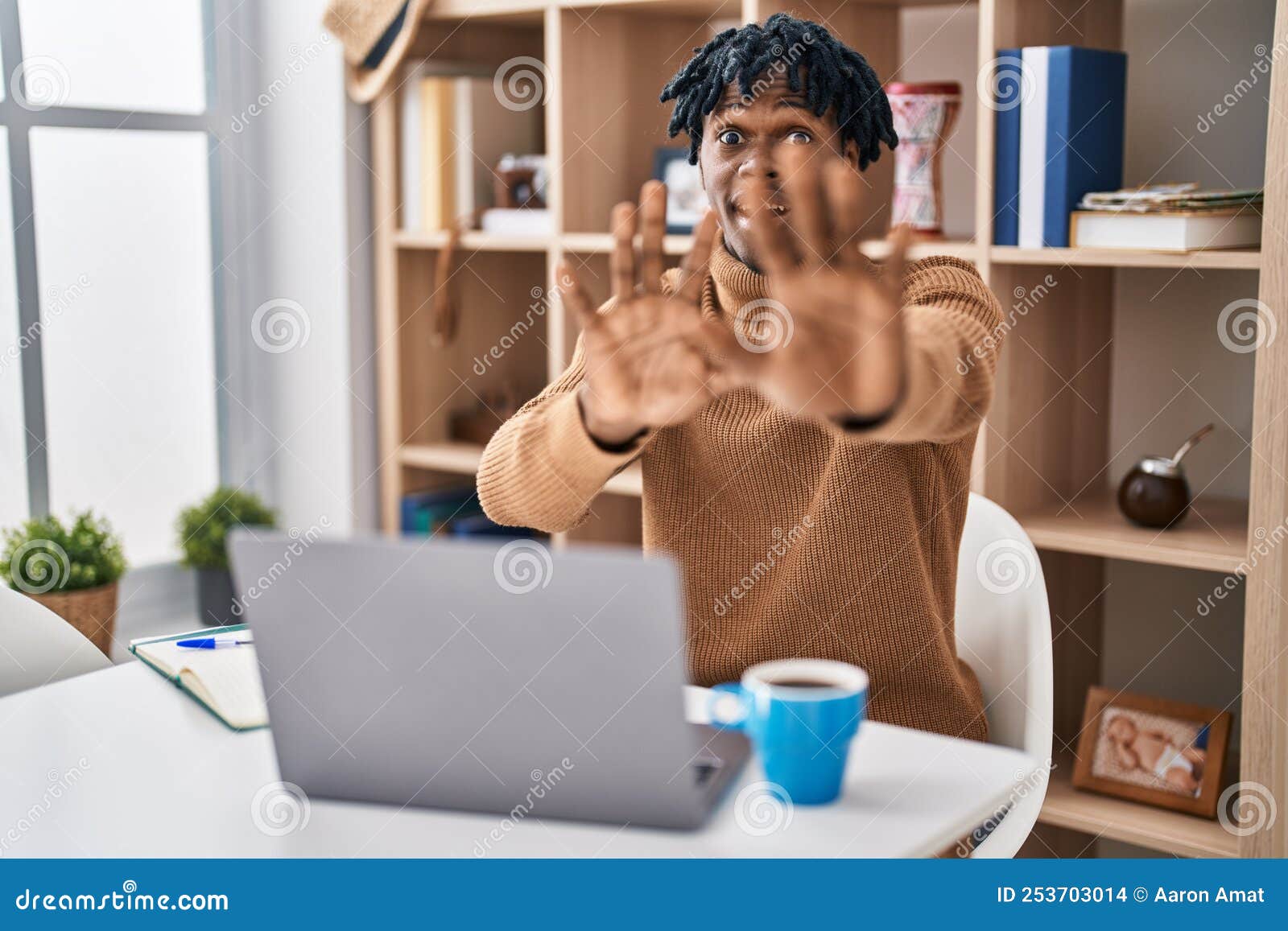 Young African Man with Dreadlocks Working Using Computer Laptop Afraid ...