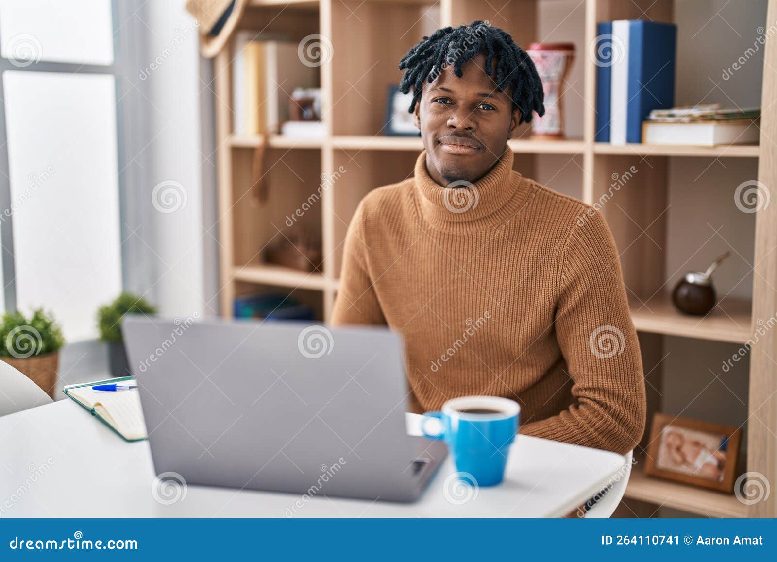 Young African Man with Dreadlocks Working Using Computer Laptop ...