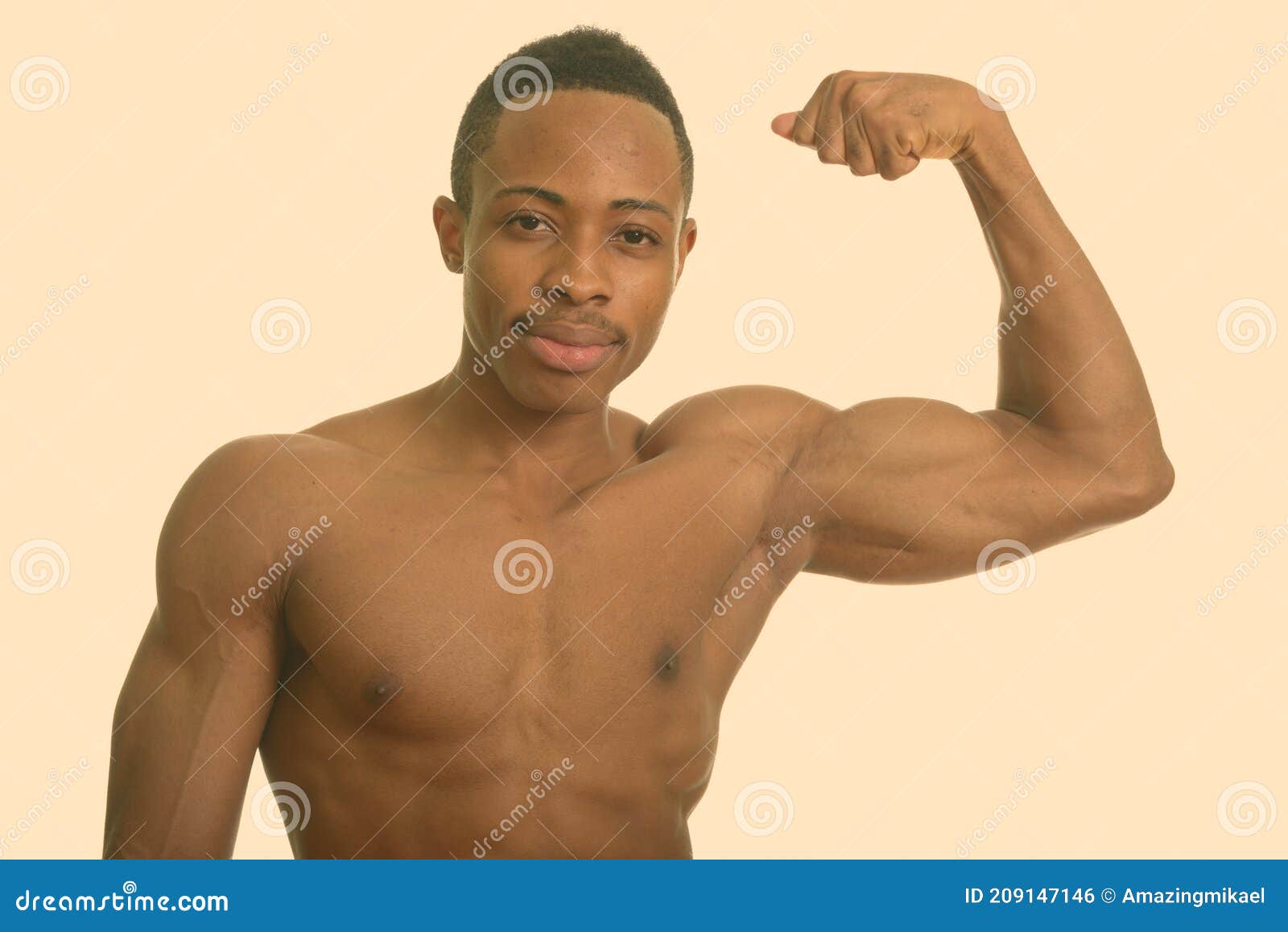 Young African Man Flexing Left Arm Stock Photo - Image of looking, left ...