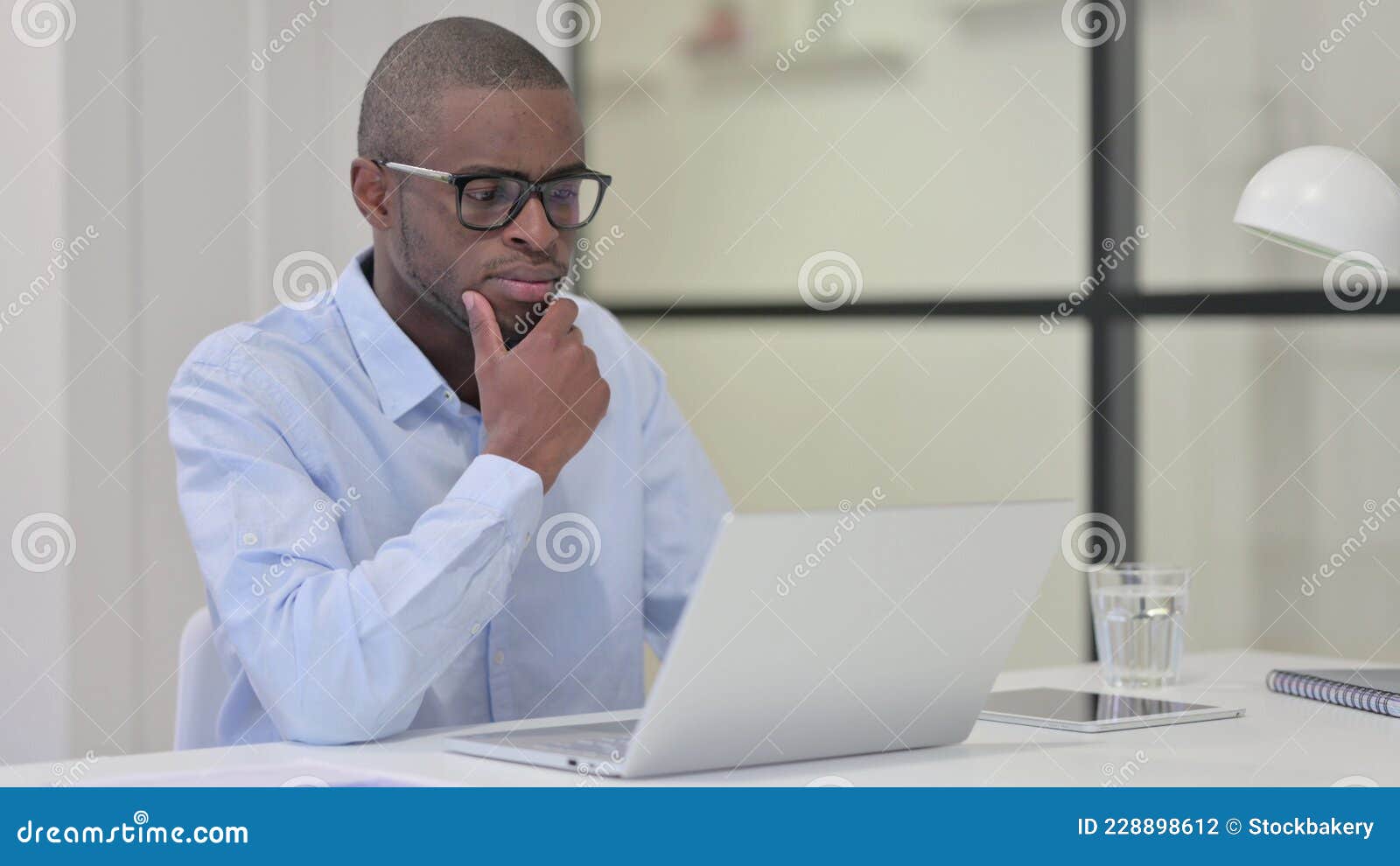 African Man with Laptop Thinking at Work Stock Photo - Image of ...