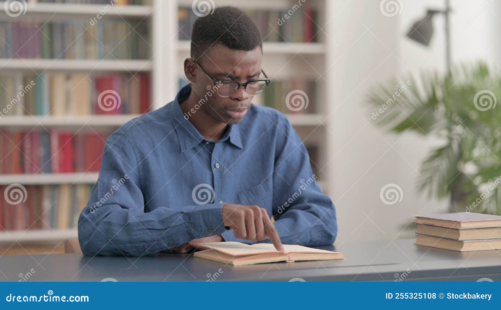 Young African Man Reading Book in Library Stock Photo - Image of read ...