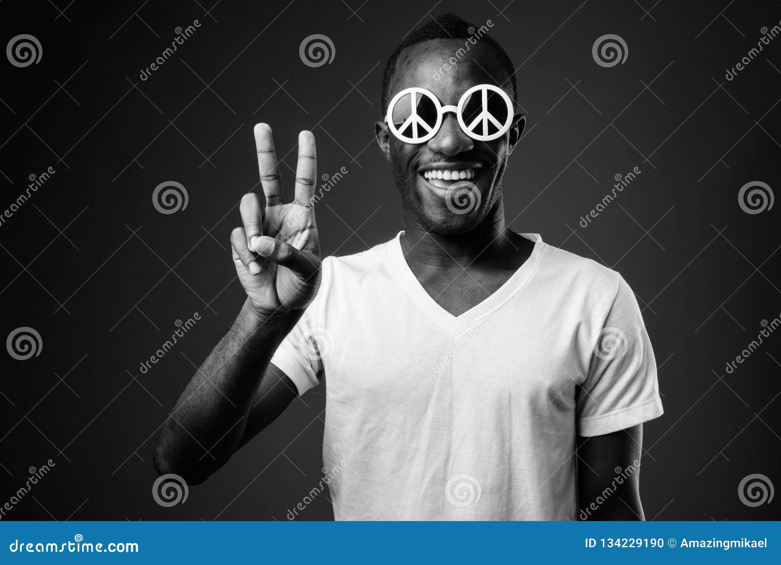 Young African Man Wearing Peace Sunglasses And Making Peaceful Gesture