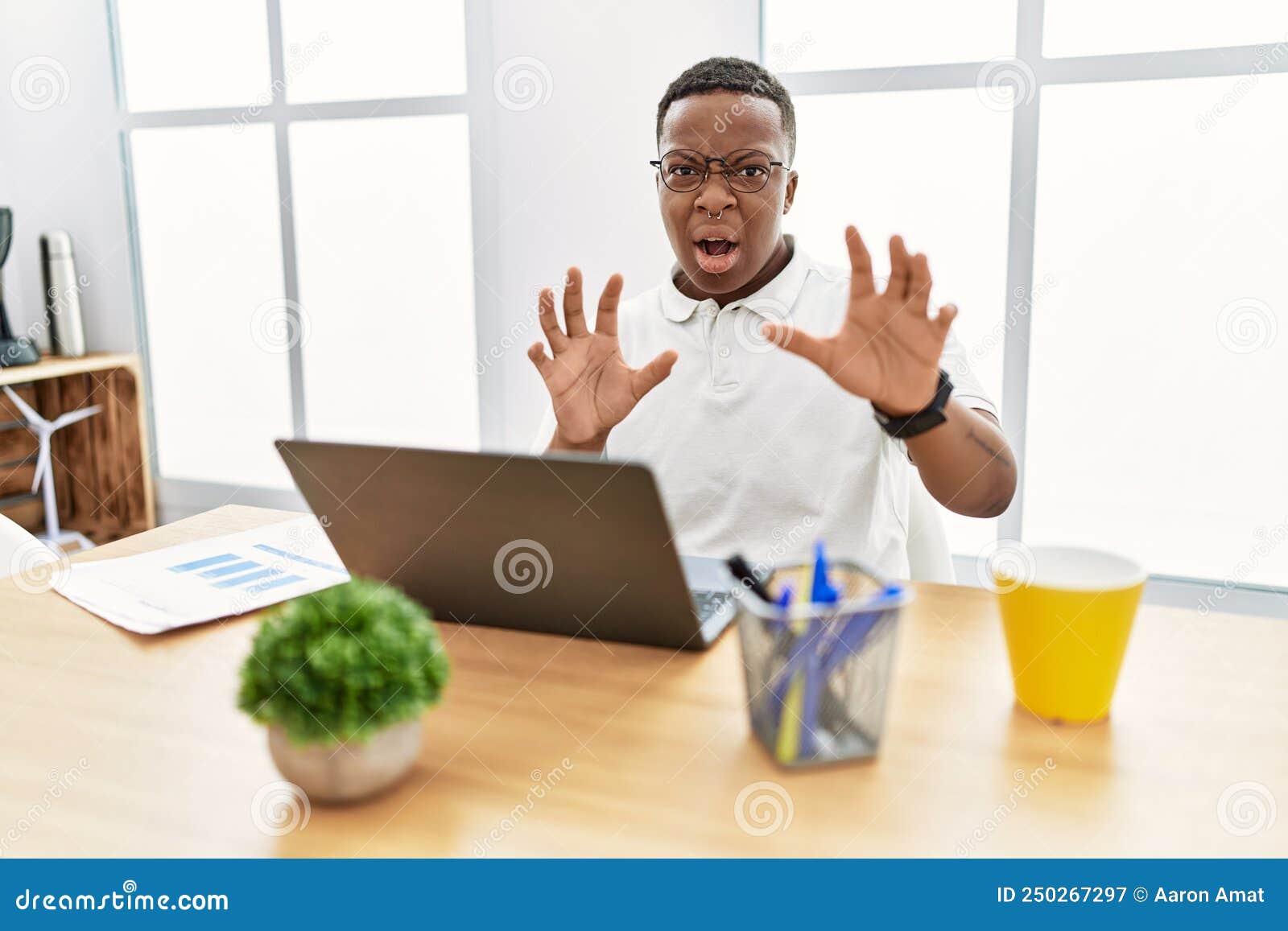 Young African Man Working at the Office Using Computer Laptop Afraid ...
